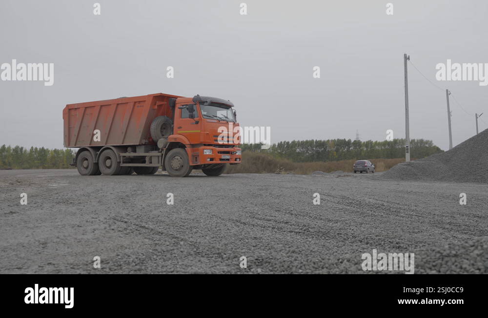 Orange tipper truck drives along gravel digging pit Stock Video Footage ...