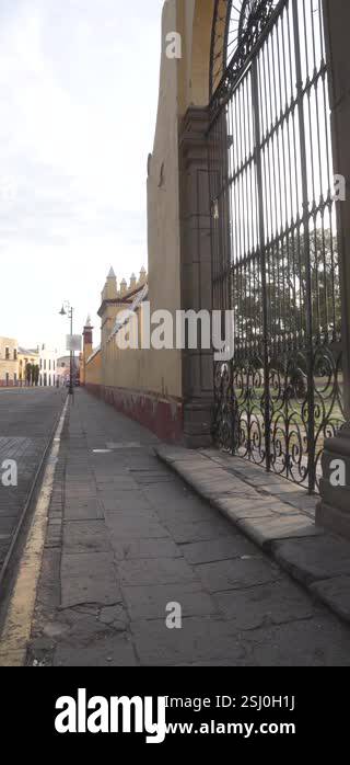 Mexican tourist photographer walks away from the camera, stops in front ...