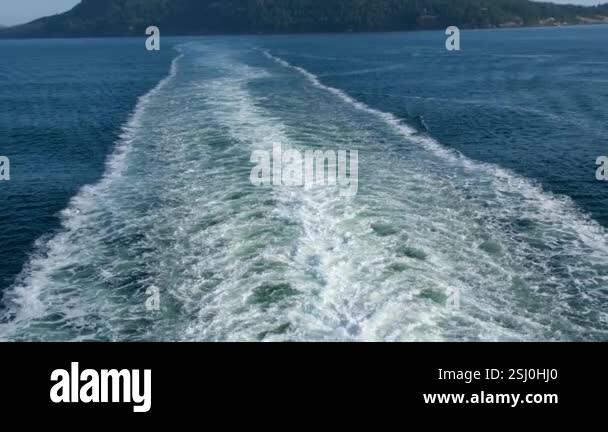 Wake of vessel. Wide wake trail from boat. Back view. Ocean water. Deep ...