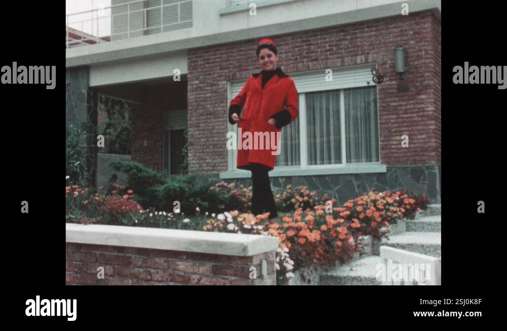1960s: Woman models antelope coat in garden near house. Woman descends ...