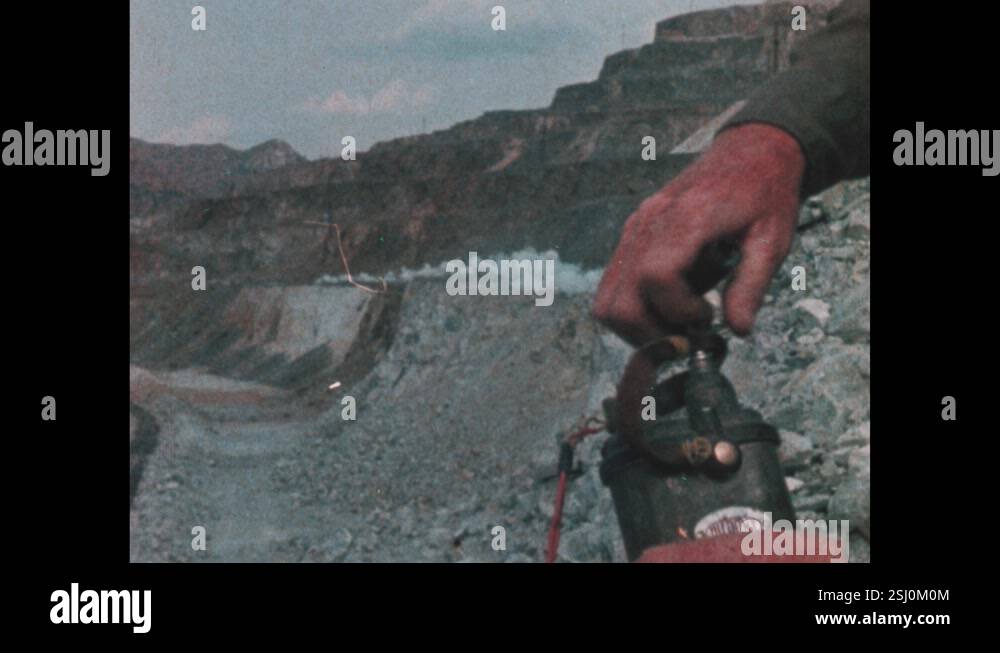 1980s: huge open pit mine, hand turns detonator, timed explosions along ...