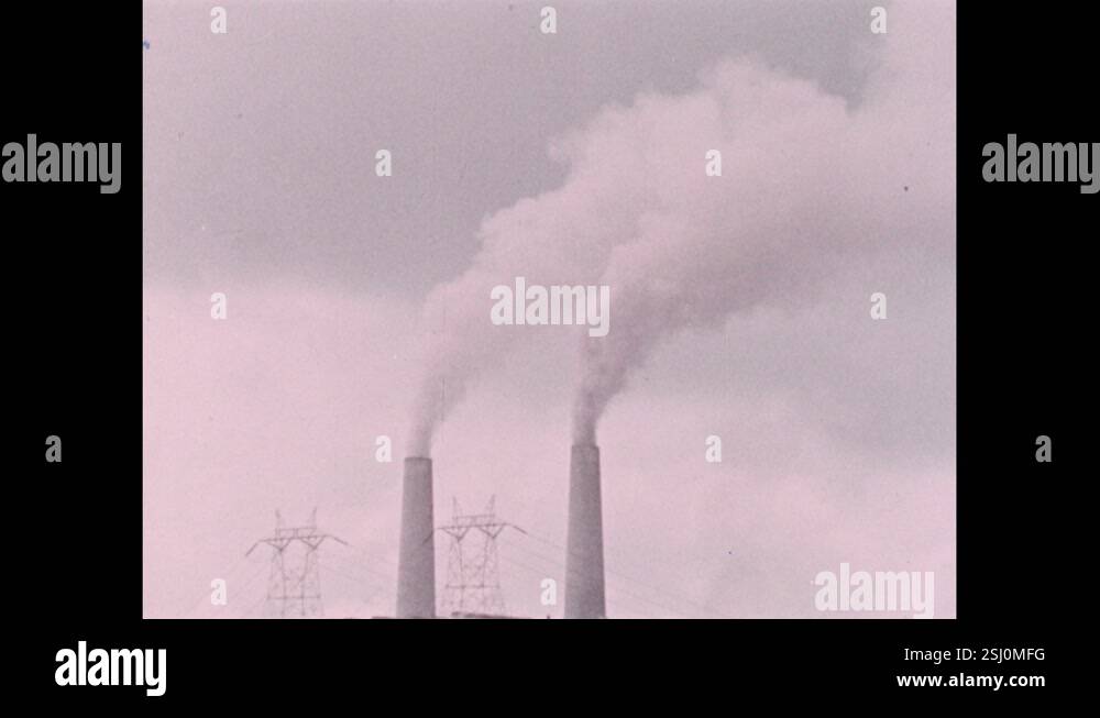 1970s: Smoke pours from stacks at a factory. Field of young corn. Dead ...