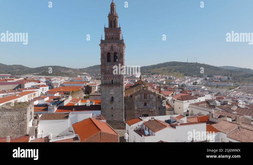 A panoramic establishing shot of a traditional Spanish town and church ...