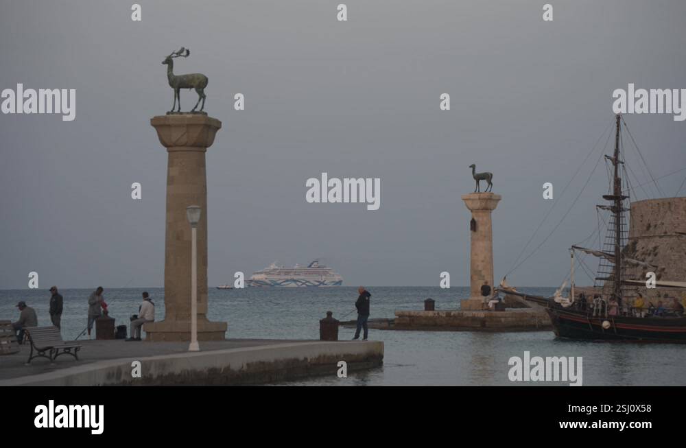 Boat, bronze stag and doe statues and Saint Nicholas Fortress, Rhodes ...