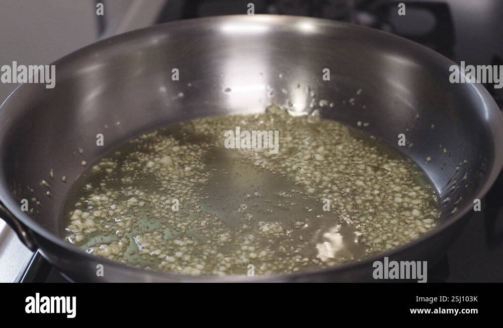 Saute minced garlic and minced onion in a frying pan.High speed Stock ...