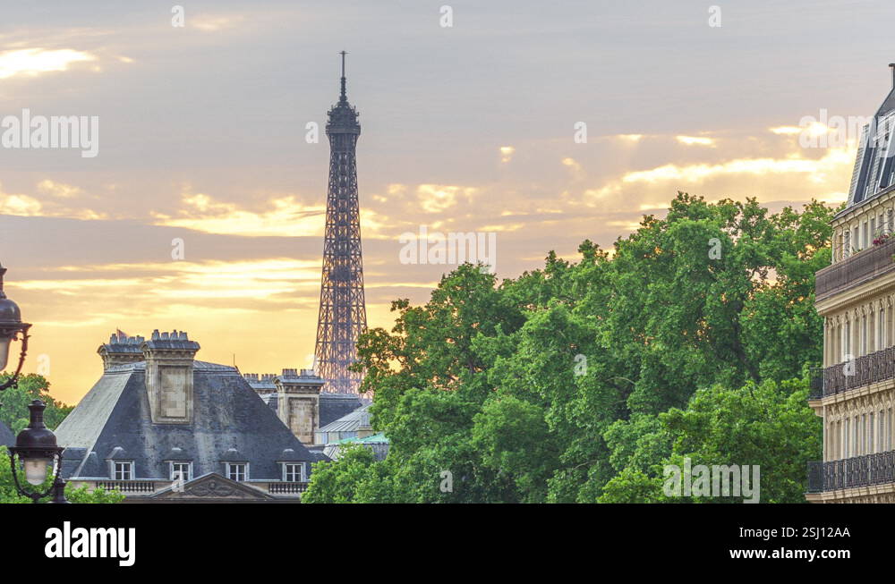Sun setting behind a building on a Parisian Soufflot street timelapse ...