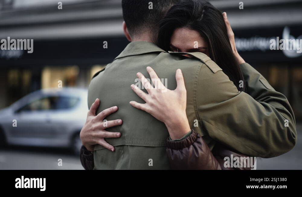 Young couple embrace in city street. Loving compassionate relationship ...