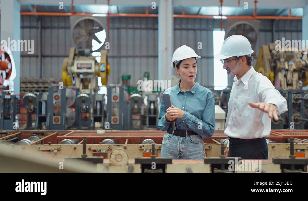 Manager leader industrial discussing project work with woman engineer ...