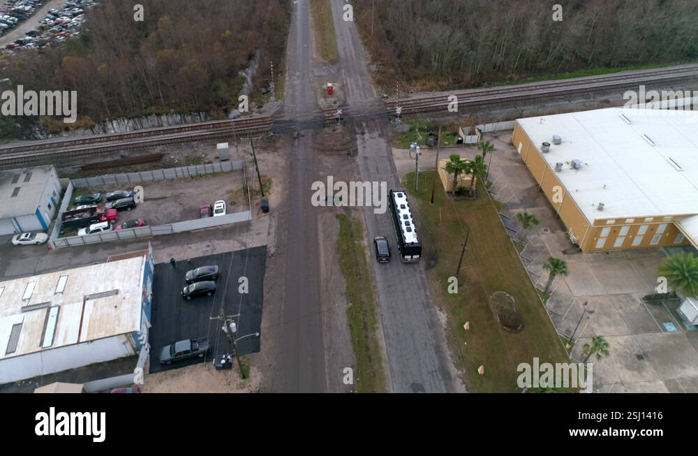 Aerial Forward Shot Of Rv Bus And Car Moving Towards Railroad Tracks On ...