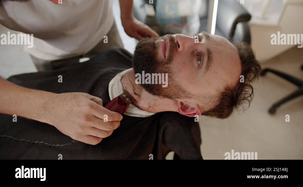 Handsome man getting new hairstyle with electric trimmer. Close Up with trimmer Stock Video ...