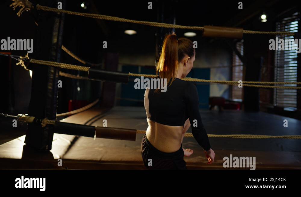 Barefooted woman boxer fighter in sportswear with ponytail going to ...