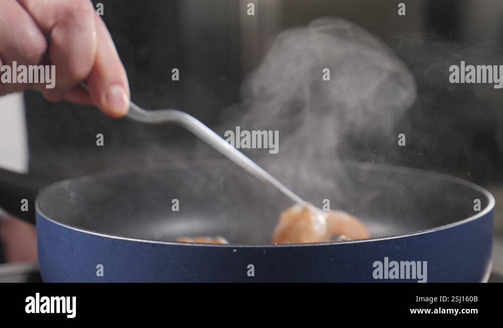 Kitchen utensils. Preparing meal on Frying pan. Smoke rising over pan ...