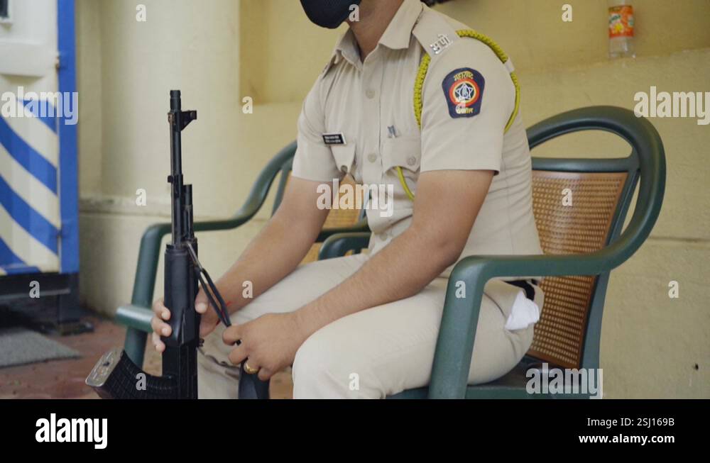Policeman alert and armed with gun on duty at a building Stock Video ...