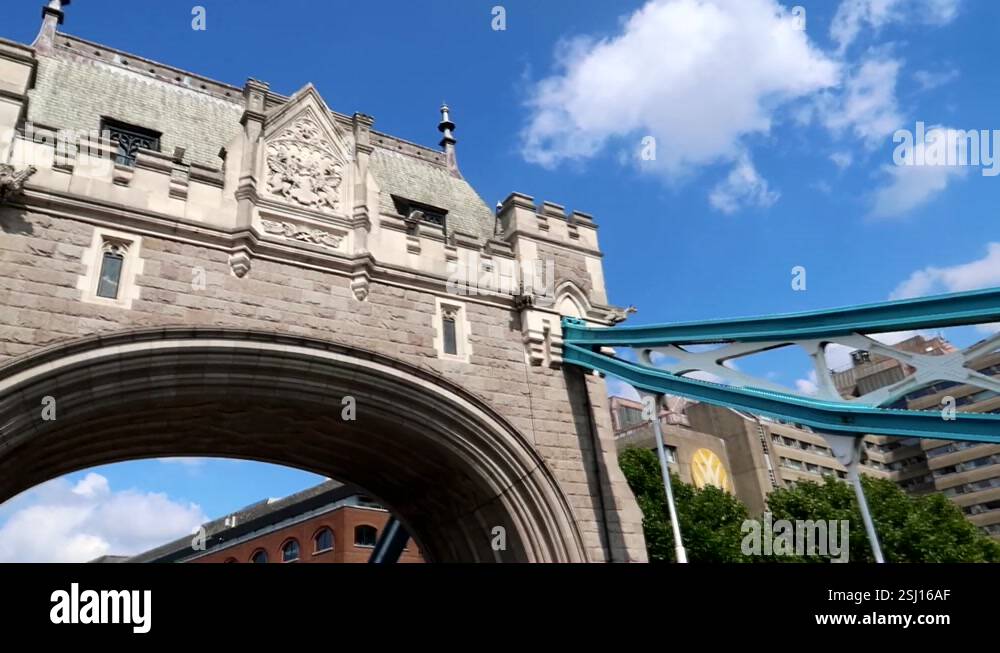 Panning left revealing Tower Bridge and its blue metal railings in the ...