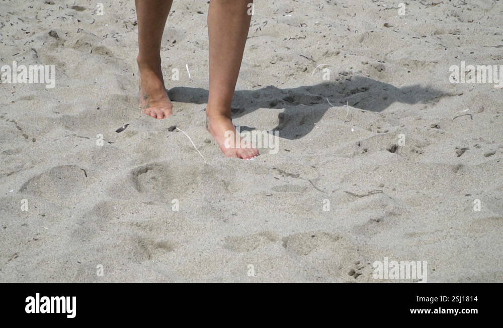 Slow motion - woman legs feet walking barefoot on the sandy beach ...