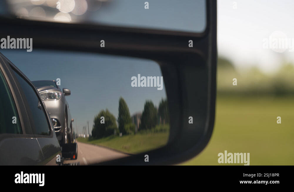 Mirror shot point of view of a car hauler hotshot pickup truck driver ...