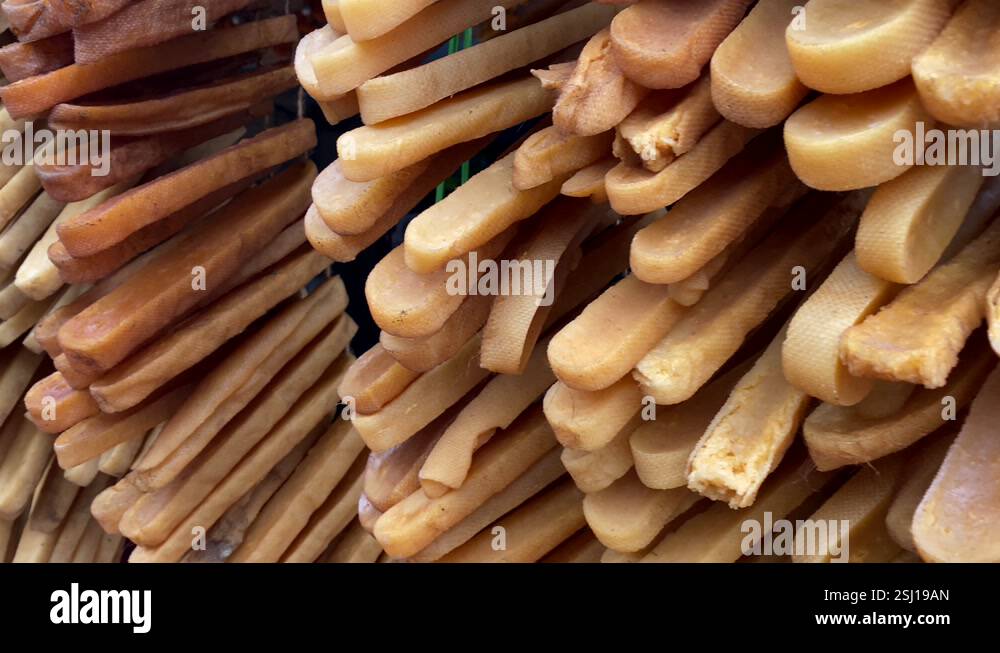 Rows and rows of Chhurpi yak cheese hanging at a local market in Ilam ...