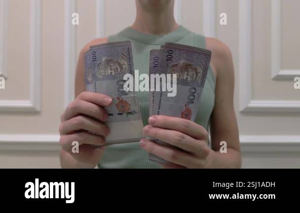 Woman counting the Malaysian ringgit - the currency of Malaysia, close ...
