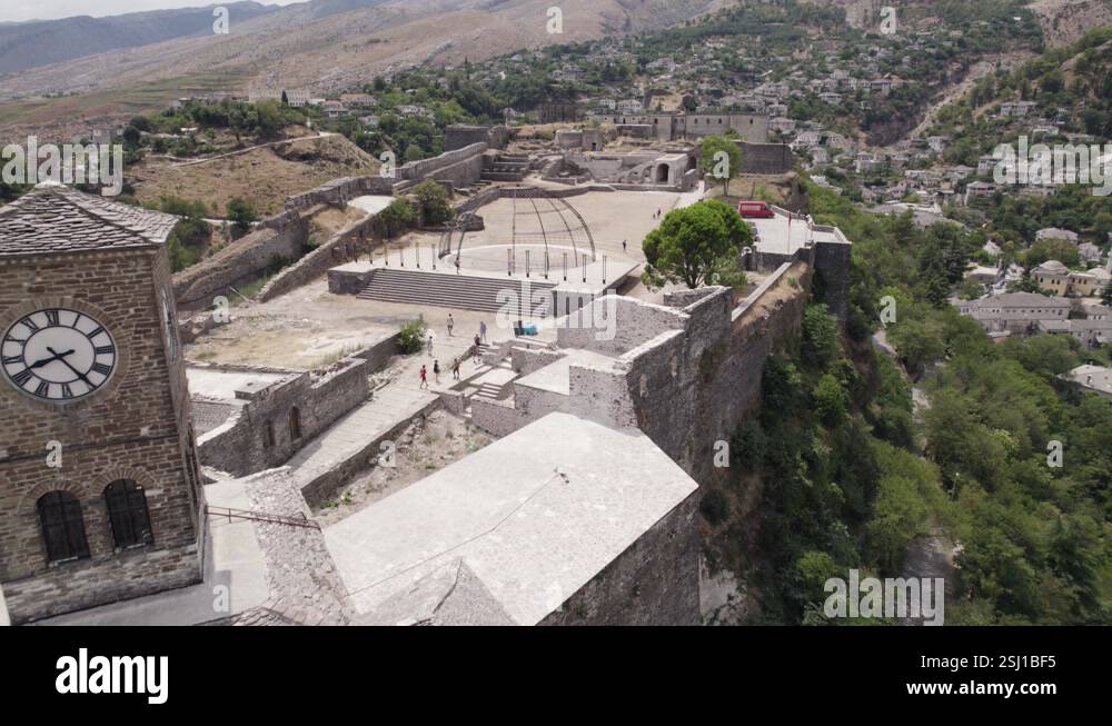 Aerial flyover Gjirokastër Castle, clock tower of fortress in ...