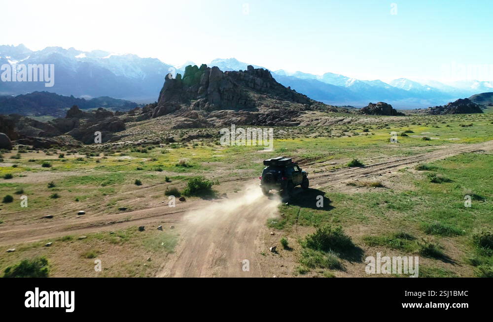 Aerial: Drone Panning Forward Shot Of Off-Road Vehicle Moving In Desert ...