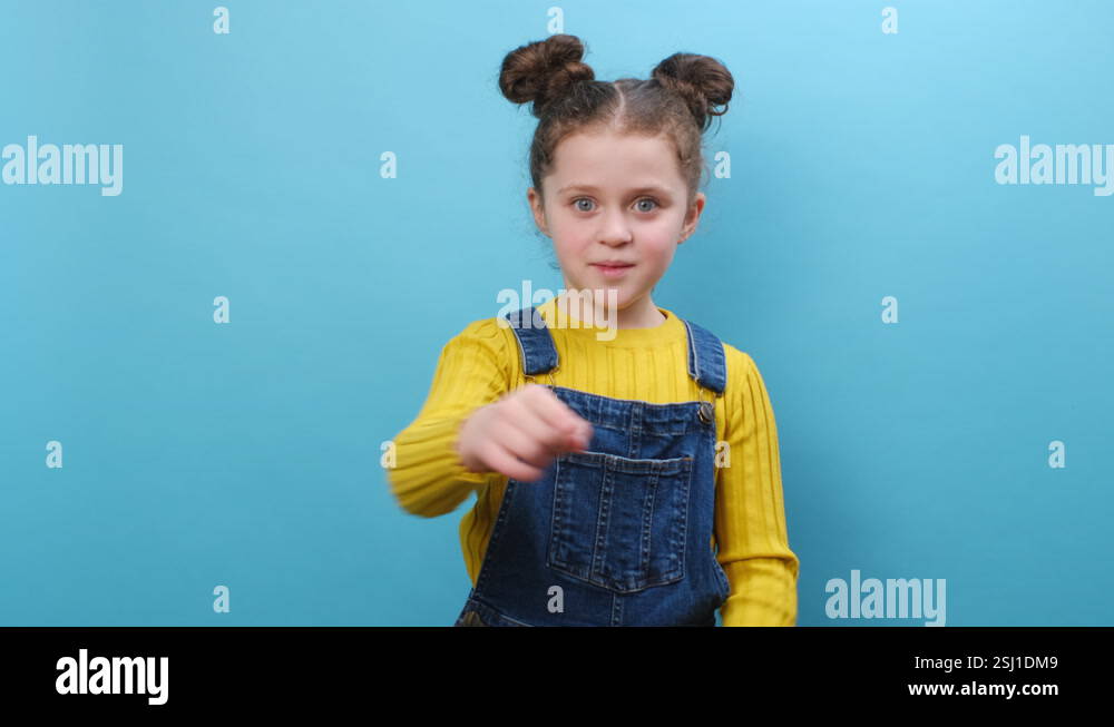 Little girl pointing finger camera on you waving, greeting with hands ...