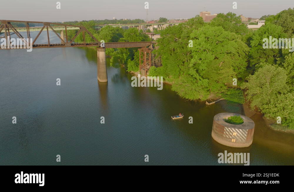 Aerial Panning Shot Of Boat Floating By Black Warrior Railroad Bridge ...
