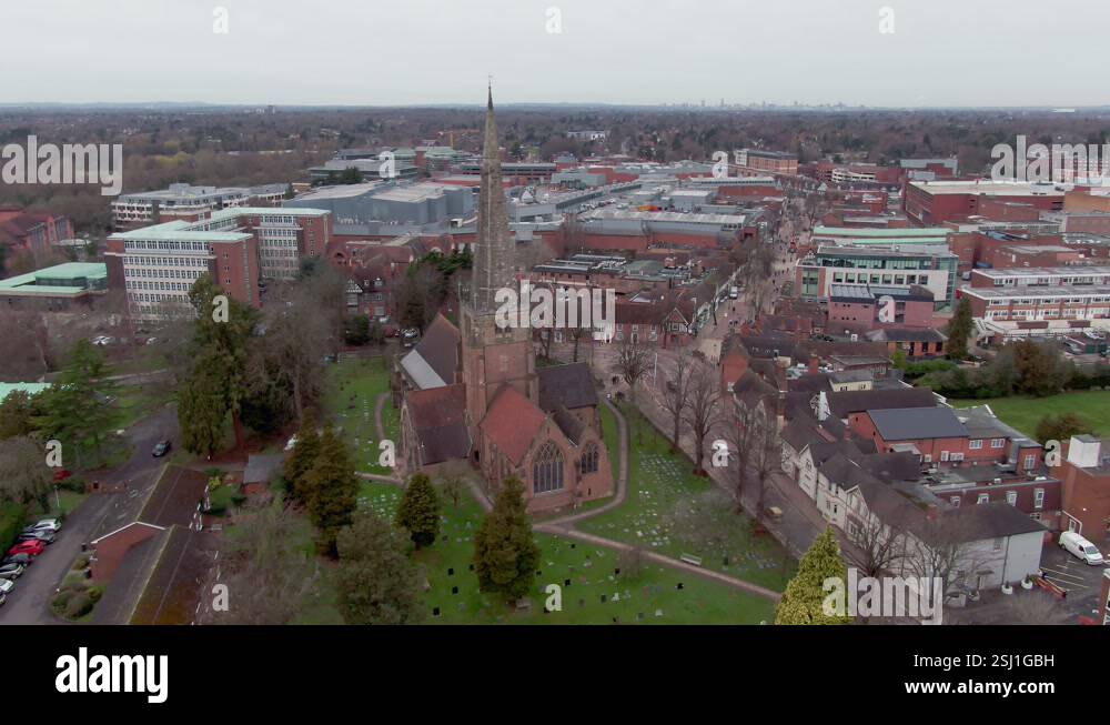 Wide orbiting drone shot showing church and city centre of Solihull ...