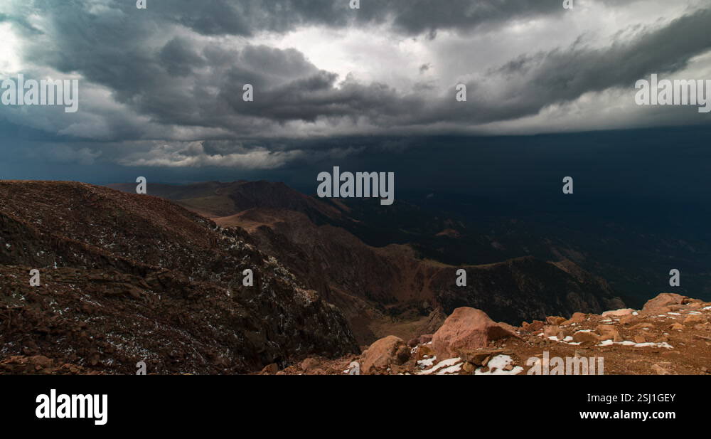 Timelapse Of Gray And Stormy Clouds Rolling Across A Rugged Mountain ...