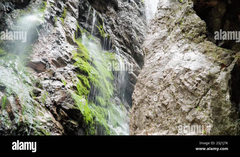 After heavy rain, water flows down the green cliff edge into the Stock ...