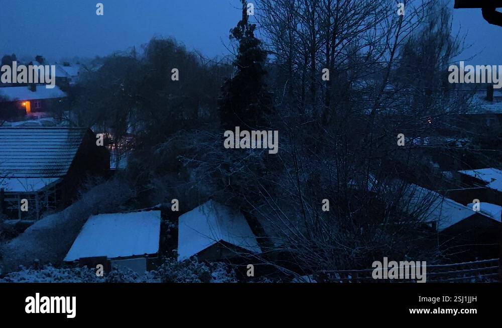 Early morning view over the snow-laden rooftops and back gardens of a ...