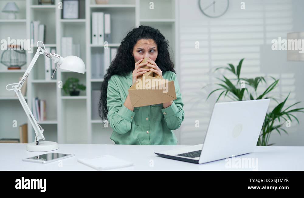 A young woman has a panic attack while working in the office at the ...