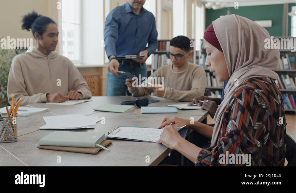 Teacher Handing Out Grammar Test To Students Stock Video Footage - Alamy