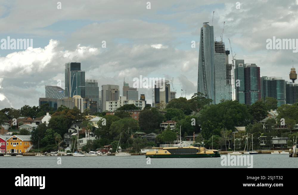 Zoom out of ferry in Sydney Harbour with modern cityscape background 4K ...