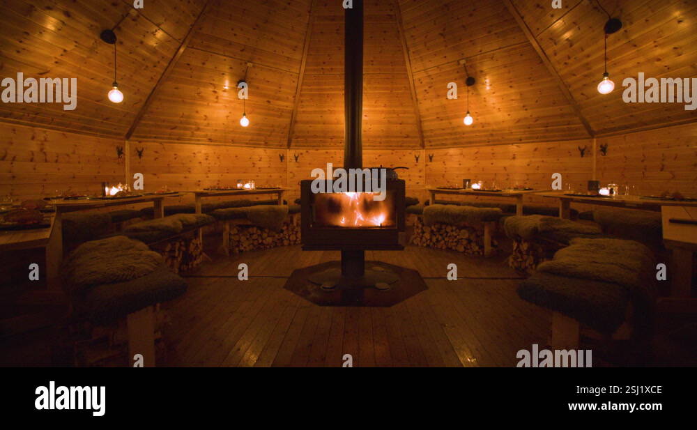 Handheld shot interior wooden Swedish rustic cabin with seating Stock ...