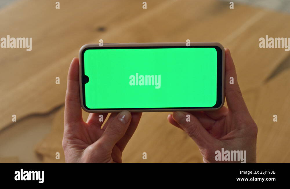 Greenscreen phone lady hands holding office close up. Woman watching ...
