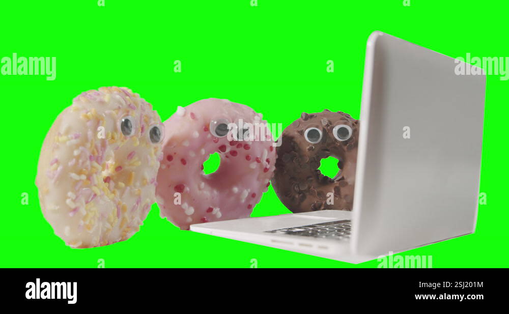 Donut using laptop. Watching content about the harmful of sugar. Green ...