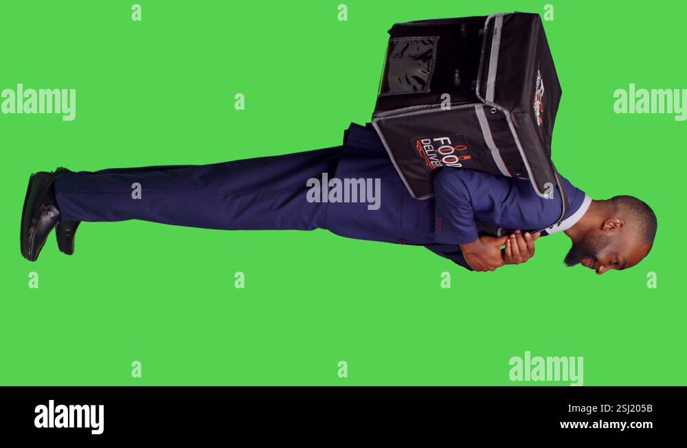 Vertical video: Profile of young deliveryman in suit giving fast food ...