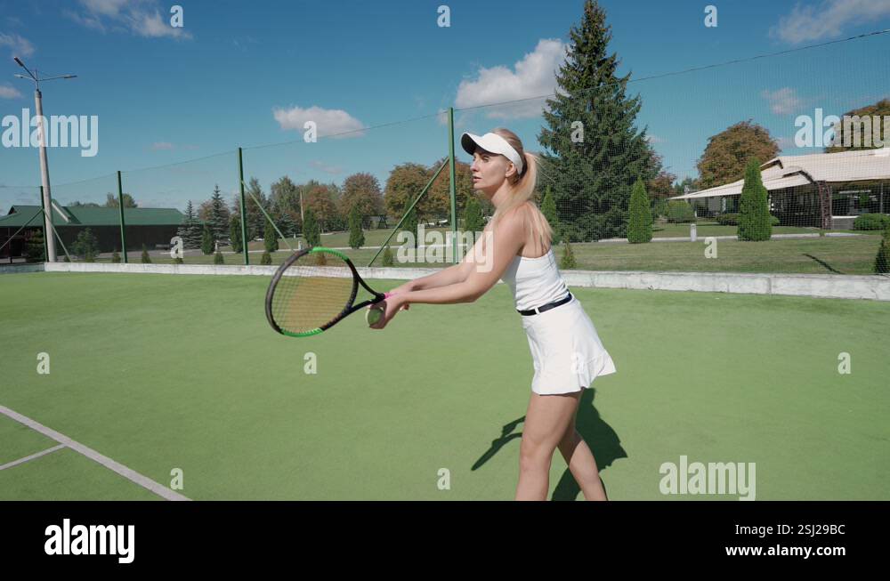 Summertime, pro tennis player hits the ball with a racket, practice ...