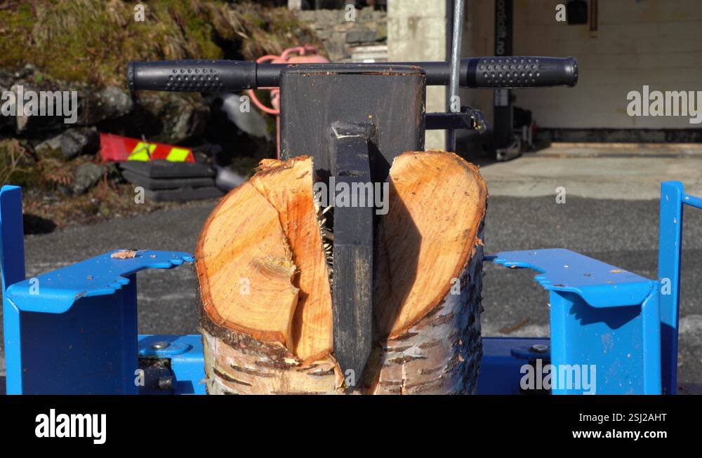 Front view of powerful wood splitter blade splitting birch log for ...