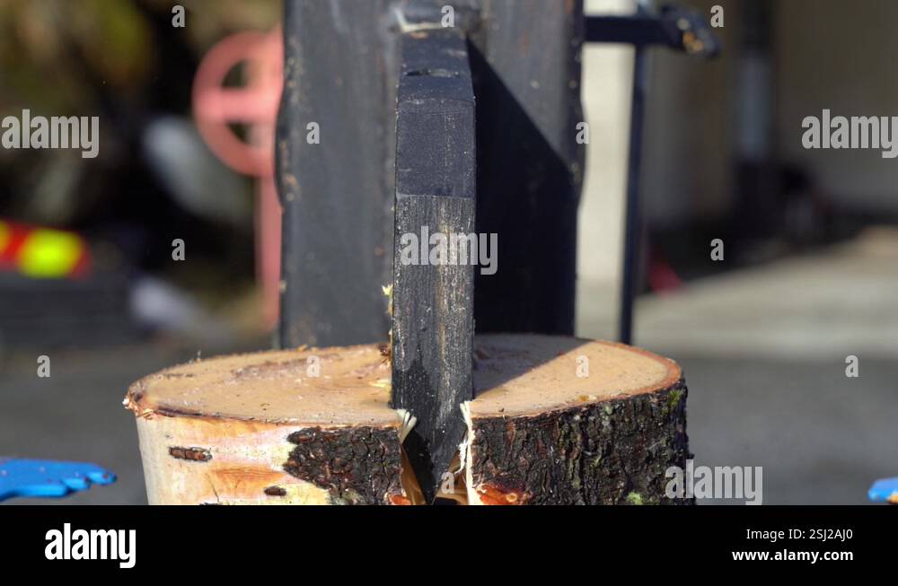 Extreme close up slow motion view of wood splitter blade splitting ...
