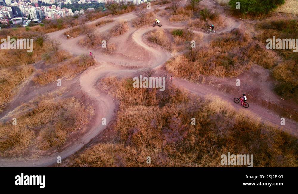Aerial shot of mountain bikers cycling and enjoying trails in Santiago ...