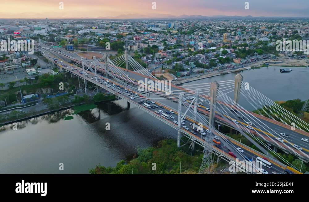 Scenic aerial of freeway bridge Juan Bosch with much traffic, sunset ...