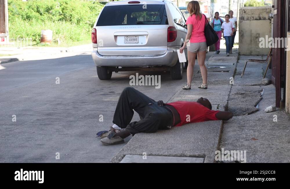 Homeless Man Sleeping on Sidewalk in Belize Stock Video Footage - Alamy