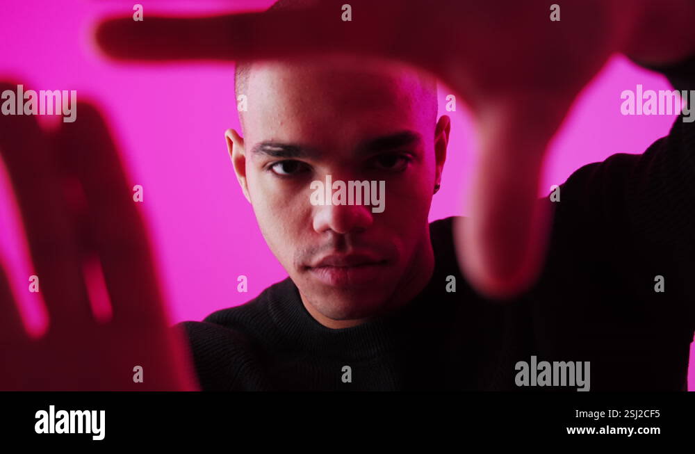 Camera frame concept. Young adult man covering camera with two hands in ...