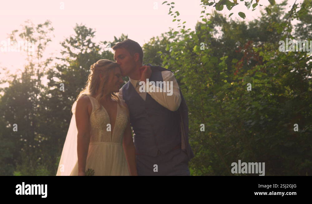 LENS FLARE, PORTRAIT: Lovely newlyweds walking by lush trees in golden ...