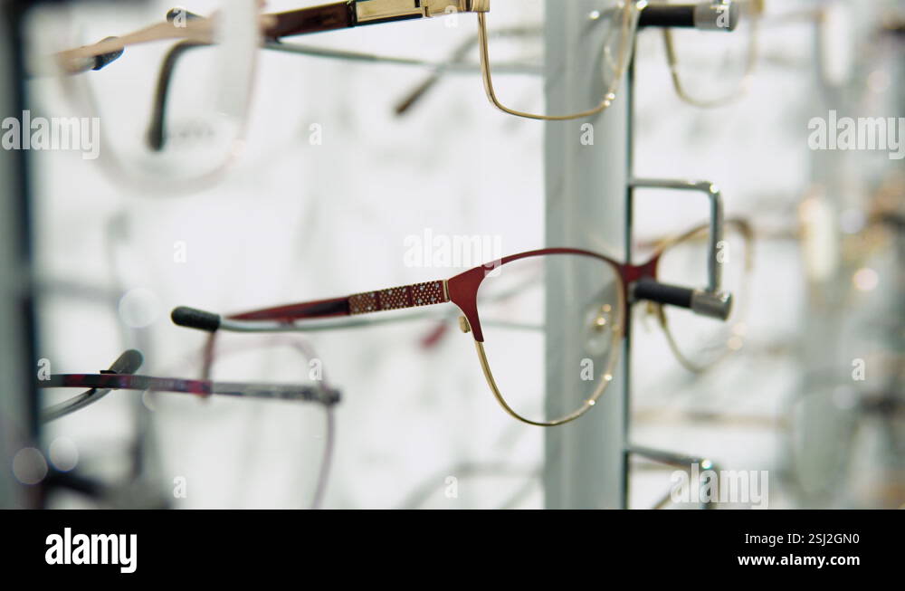 Showcase with spectacles in modern ophthalmic store. Glasses on display ...