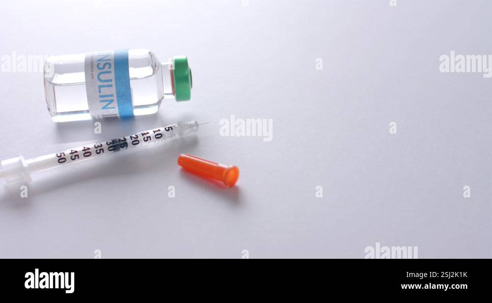 Close up of insulin vial and syringe on white background with copy ...