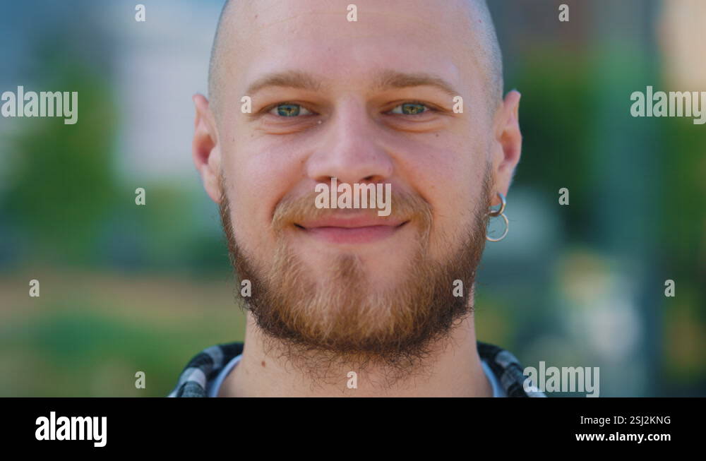 Portrait of the beard caucasian man standing outside in the park. Male ...