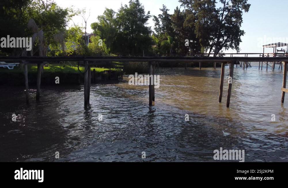 Empty wooden dock along Parana river delta, Argentina. Aerial sideways ...