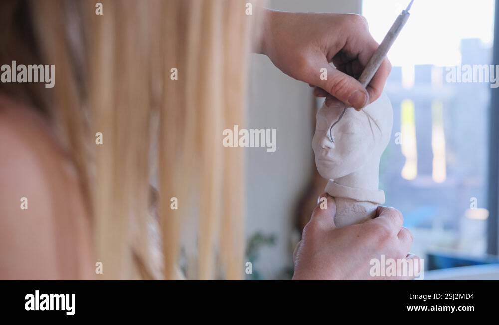 a female sculptor creates a sculptural bust of a clay human woman Stock ...
